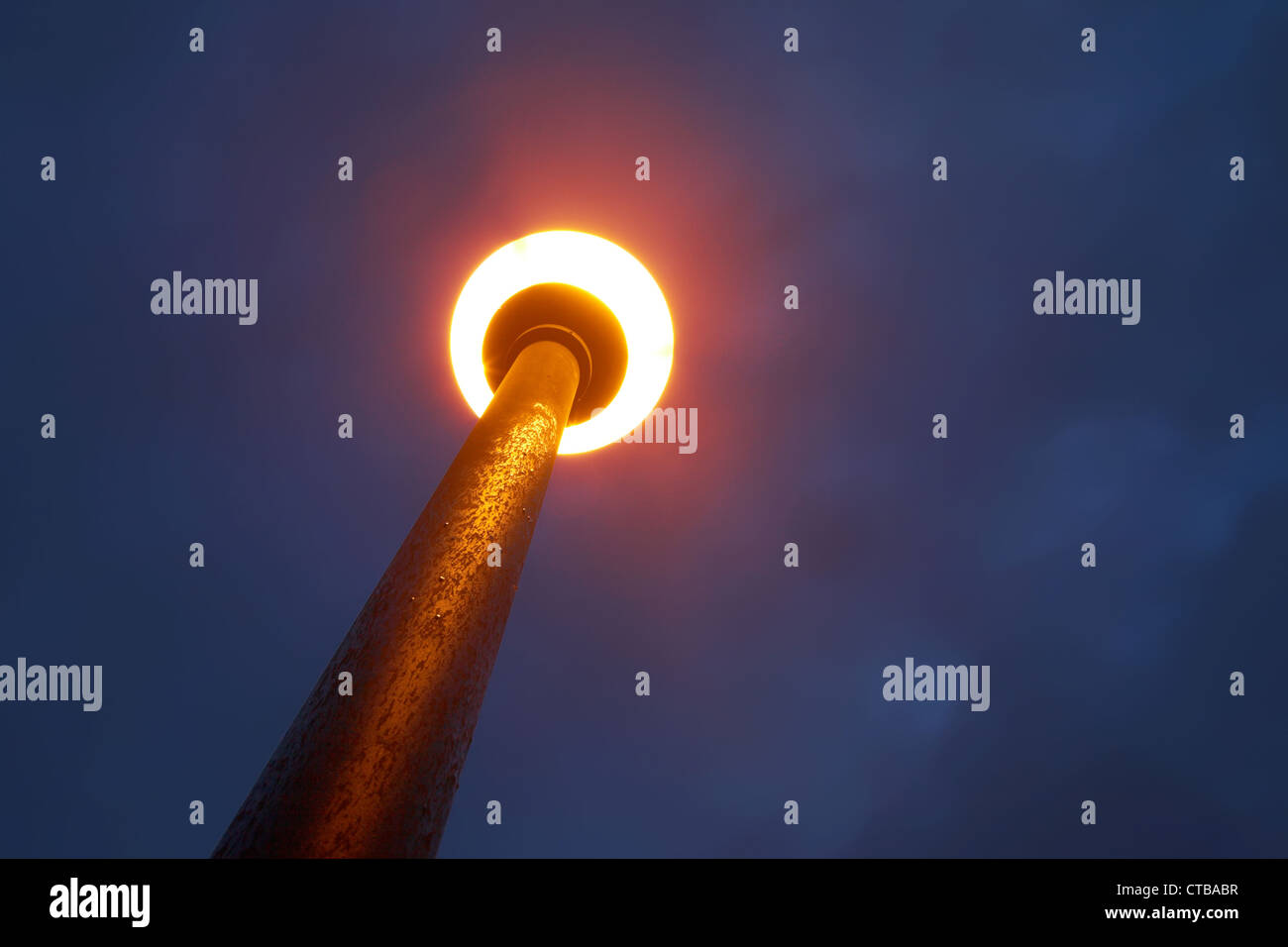 Light pollution concept: a streetlight over a blue dark sky at evening ...