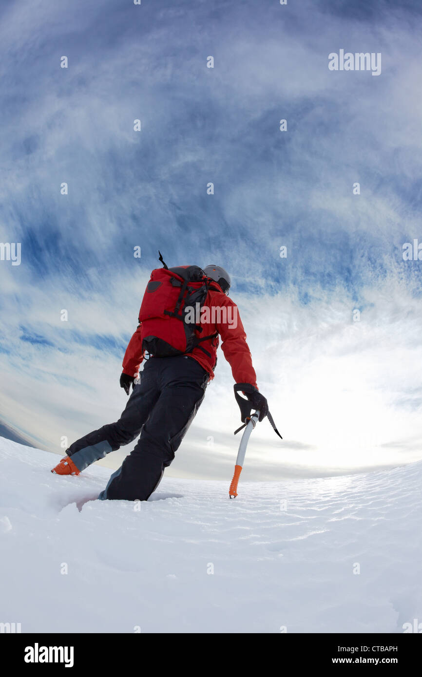 Mountaineer reaching the top of a snowy mountain. Vertical frame Stock ...