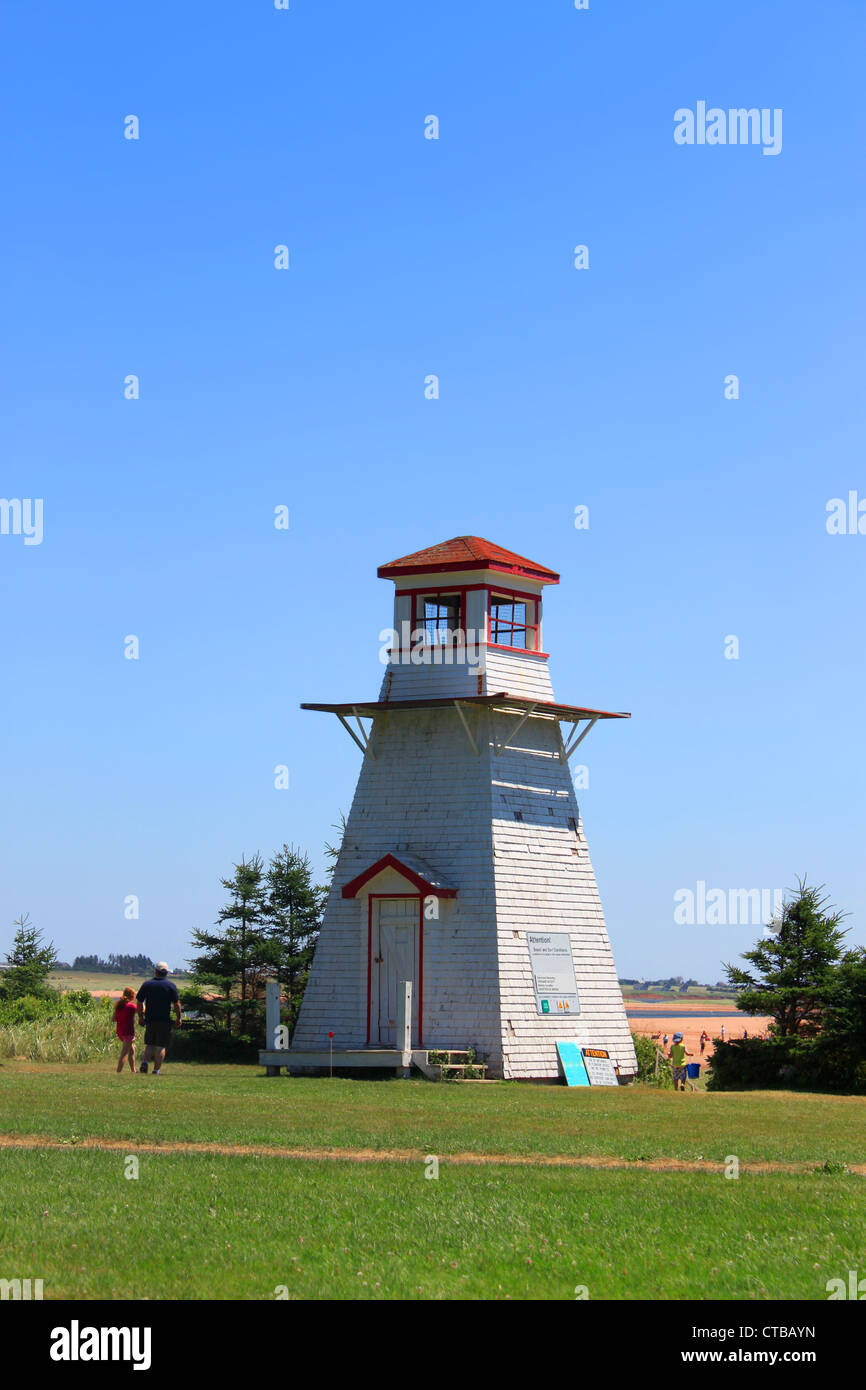 Lighthouse at Cabot Beach with beach-goers in Prince Edward Island ...