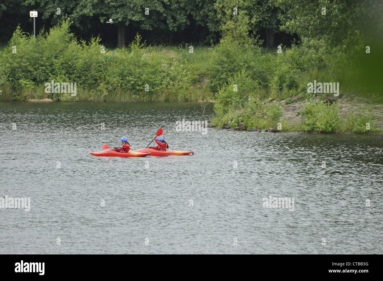 Two young canoeists on Debdale Park lower reservoir paddling about ...