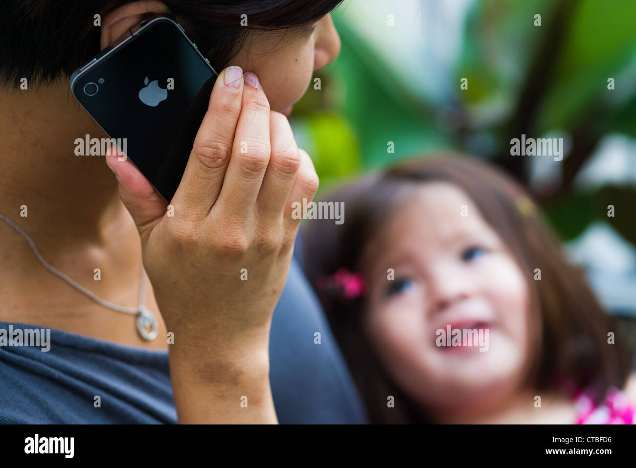 Mother and child with iPhone 4 Stock Photo - Alamy