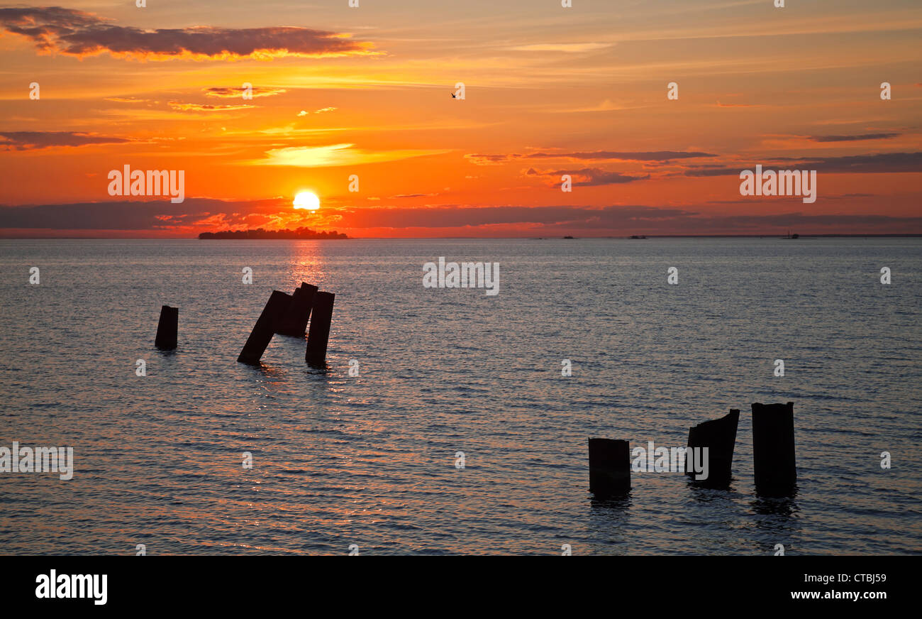 Parts of a broken sea pier at the sunset Stock Photo - Alamy