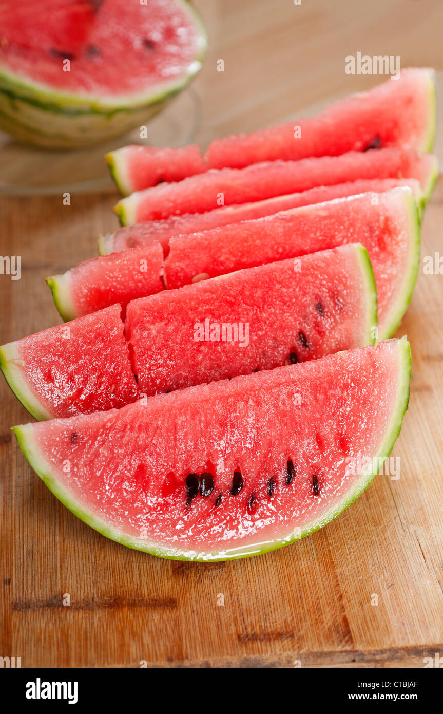 fresh ripe watermelon sliced on a wood table Stock Photo - Alamy