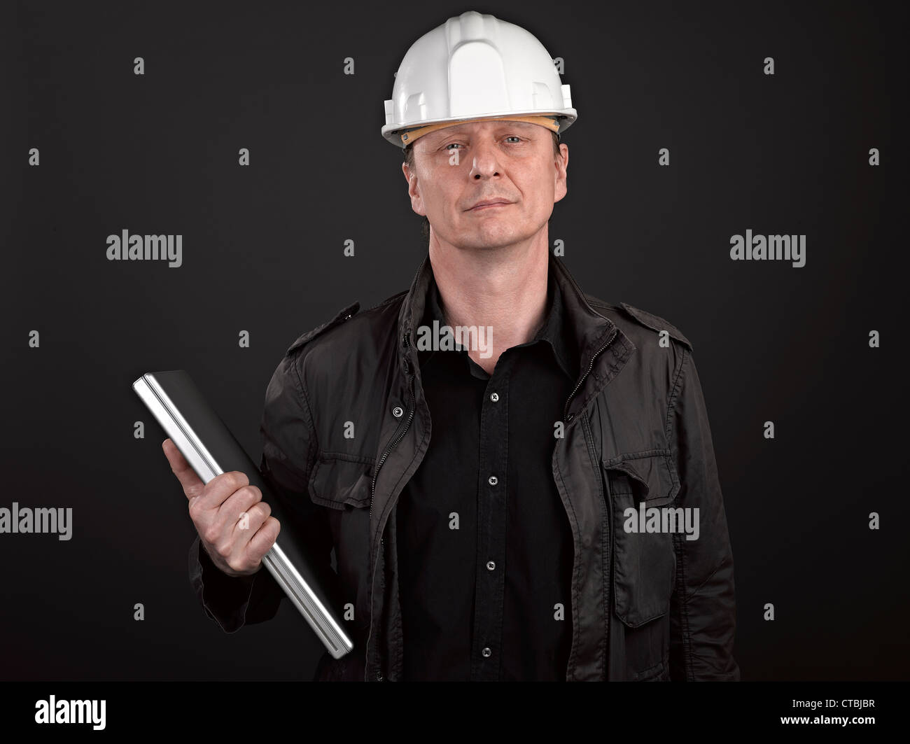 Portrait of a man architect on black background Stock Photo - Alamy