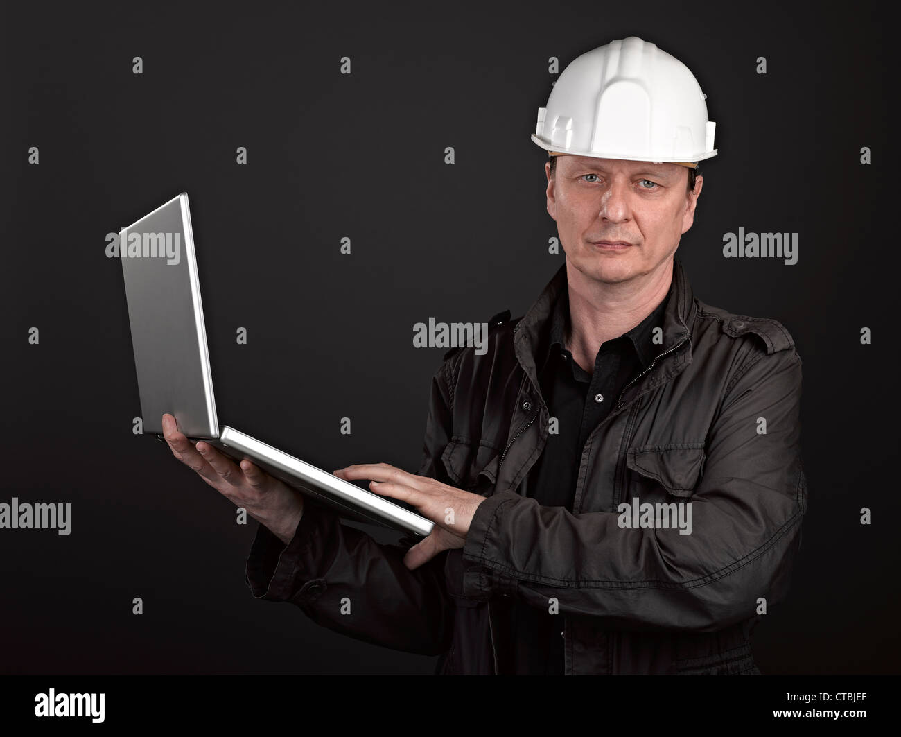 Portrait of man architect on black background Stock Photo - Alamy