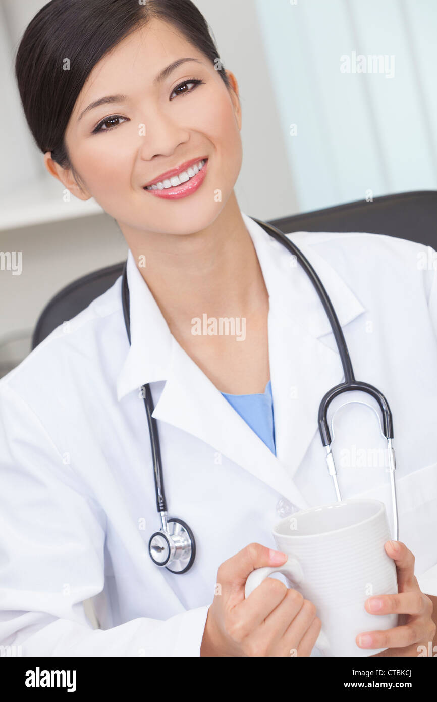 A Chinese Asian female medical doctor drinking tea or coffee in a ...