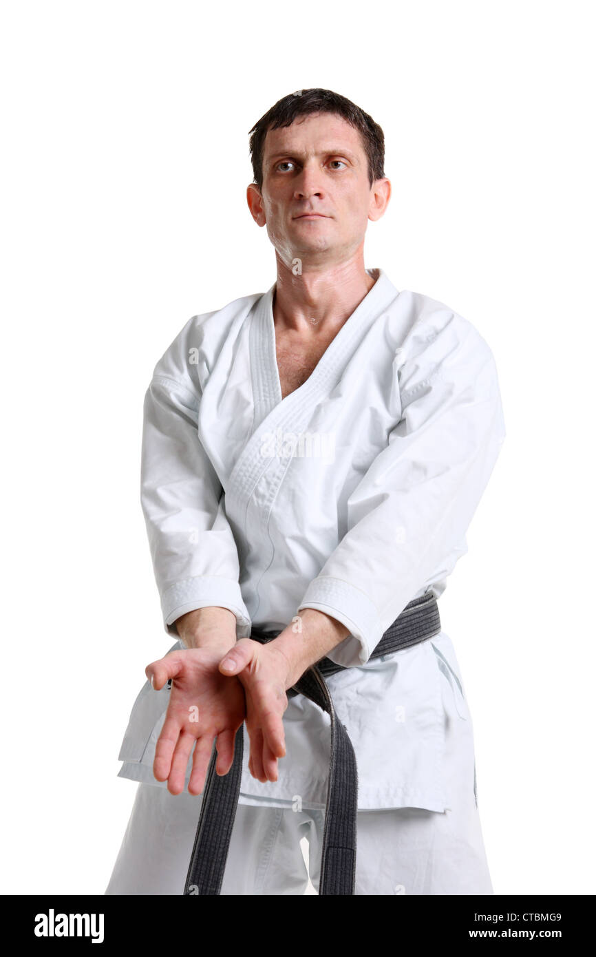 Karate. Man in a kimono with a white background Stock Photo - Alamy