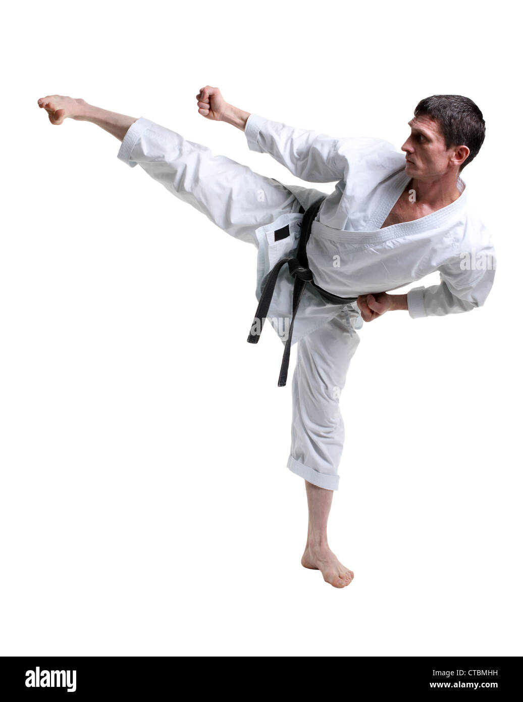 Karate. Man in a kimono hits foot on the white background Stock Photo ...