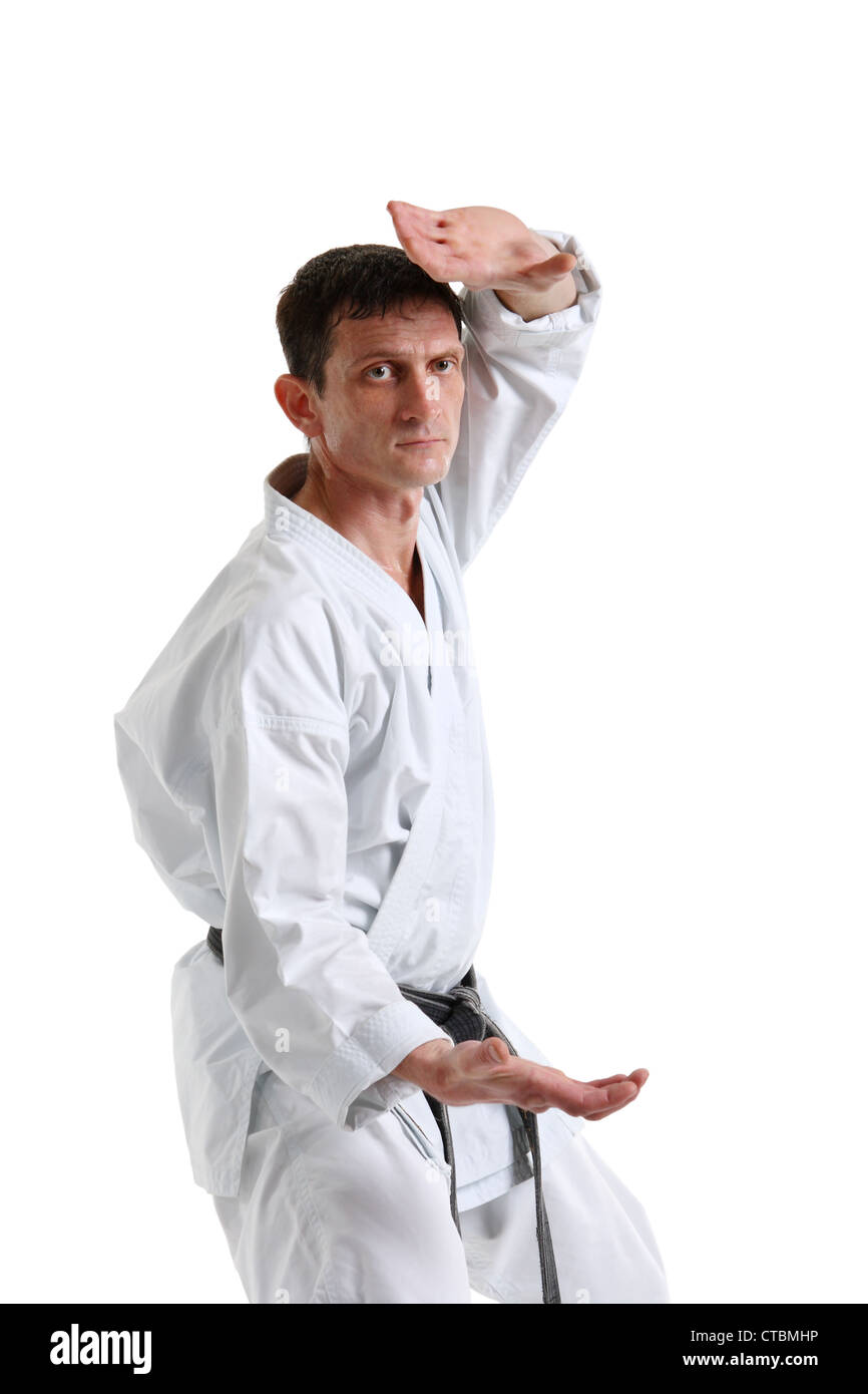 Karate. Man in a kimono with a white background Stock Photo - Alamy