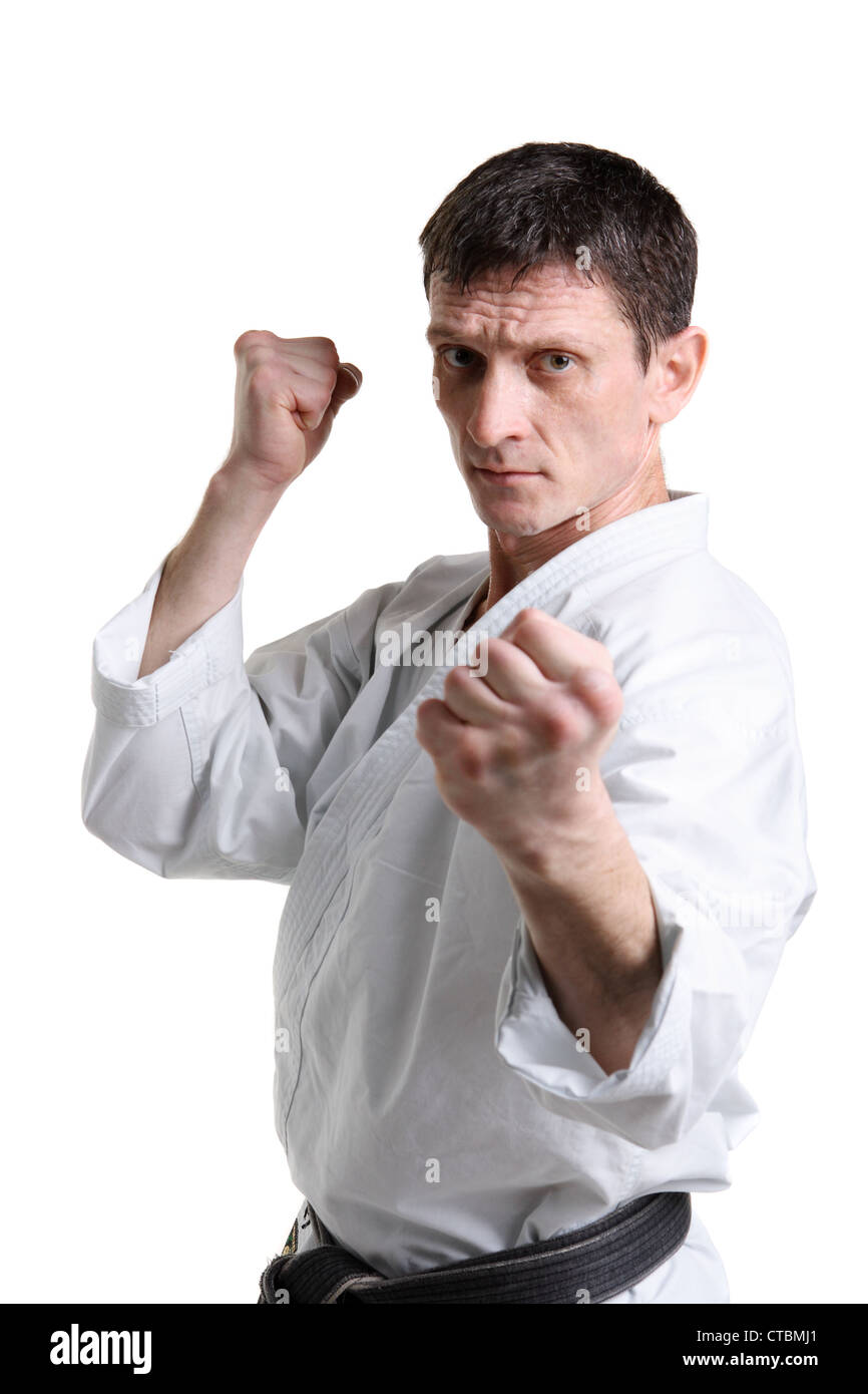 Karate. Man in a kimono with a white background Stock Photo - Alamy