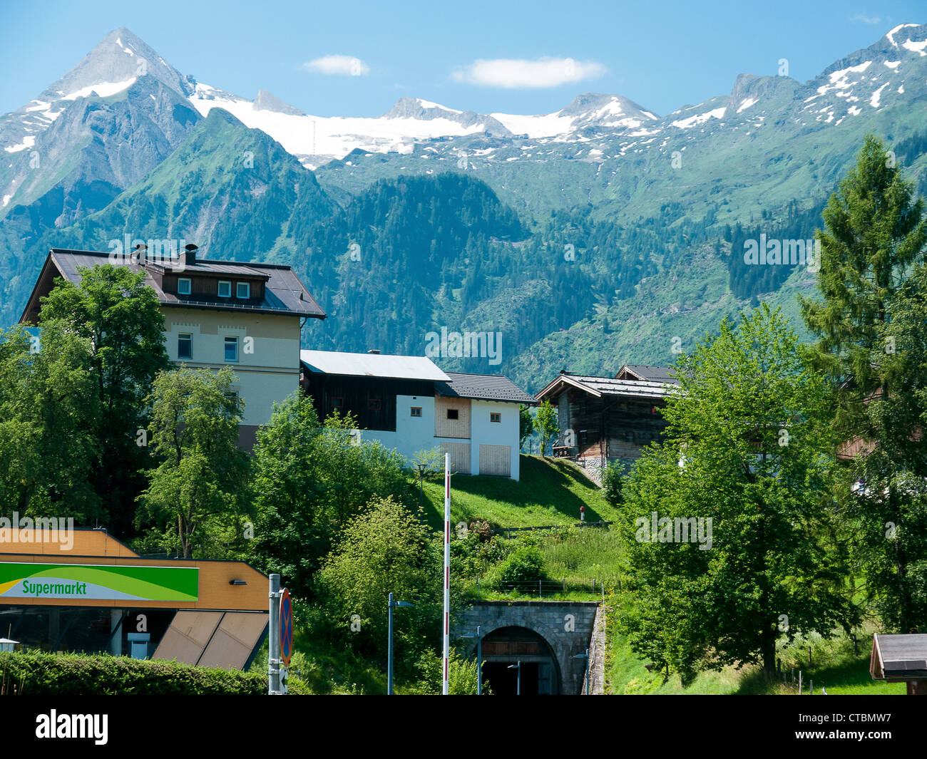 Alpine scene with snow topped mountain in Tyrolean village of Kaprun at ...