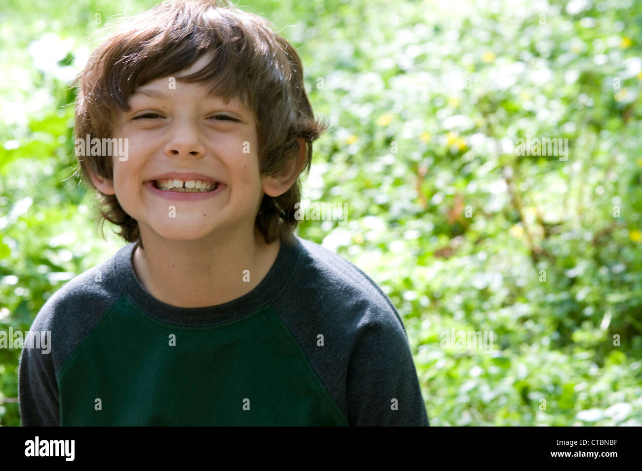 Portrait of a boy with a cheeky grin Stock Photo - Alamy
