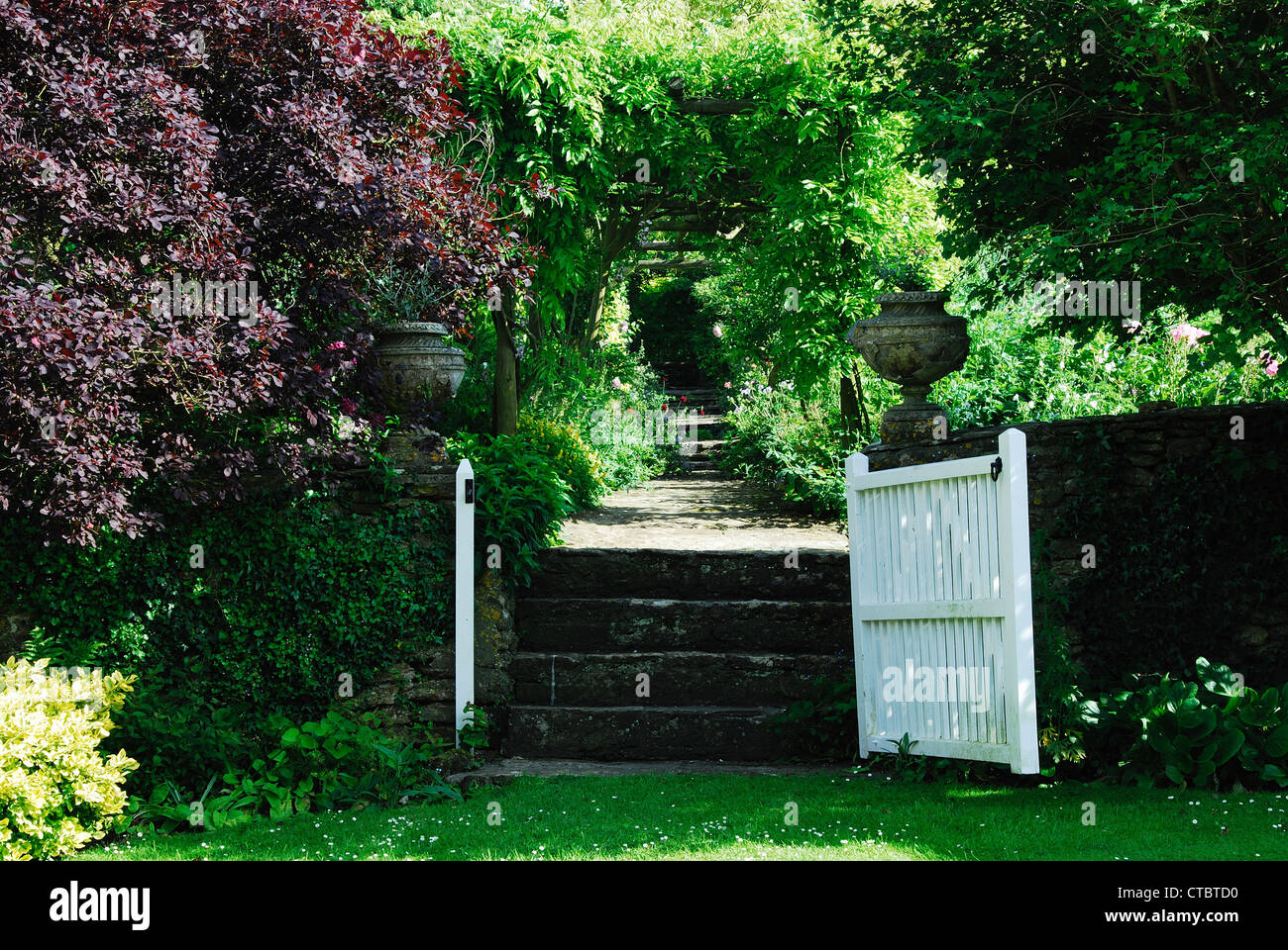 An open gate leading into a garden UK Stock Photo - Alamy