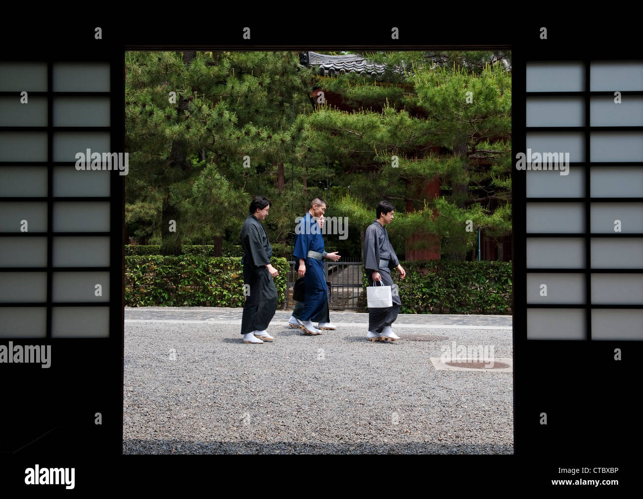 A group of Japanese men wearing yukata, lightweight summer kimonos, in ...