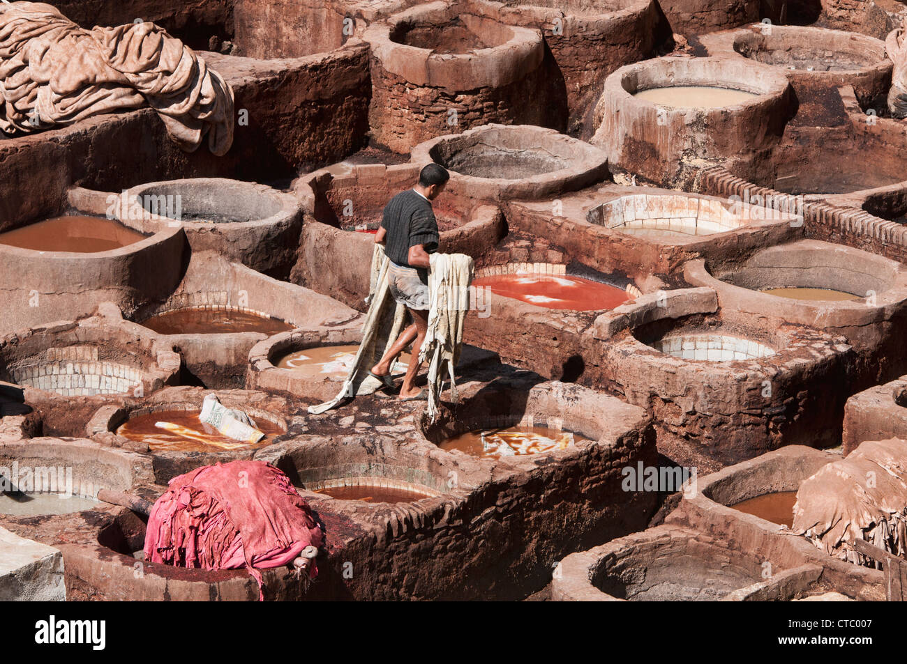 worker in the thousand year old leather tannery in the ancient medina ...