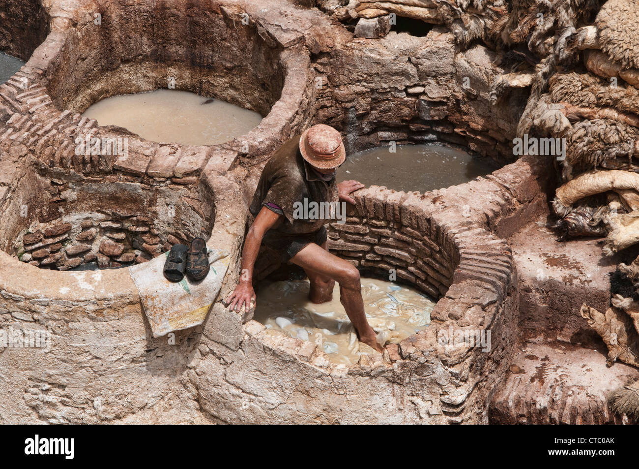 worker in the thousand year old leather tannery in the ancient medina ...