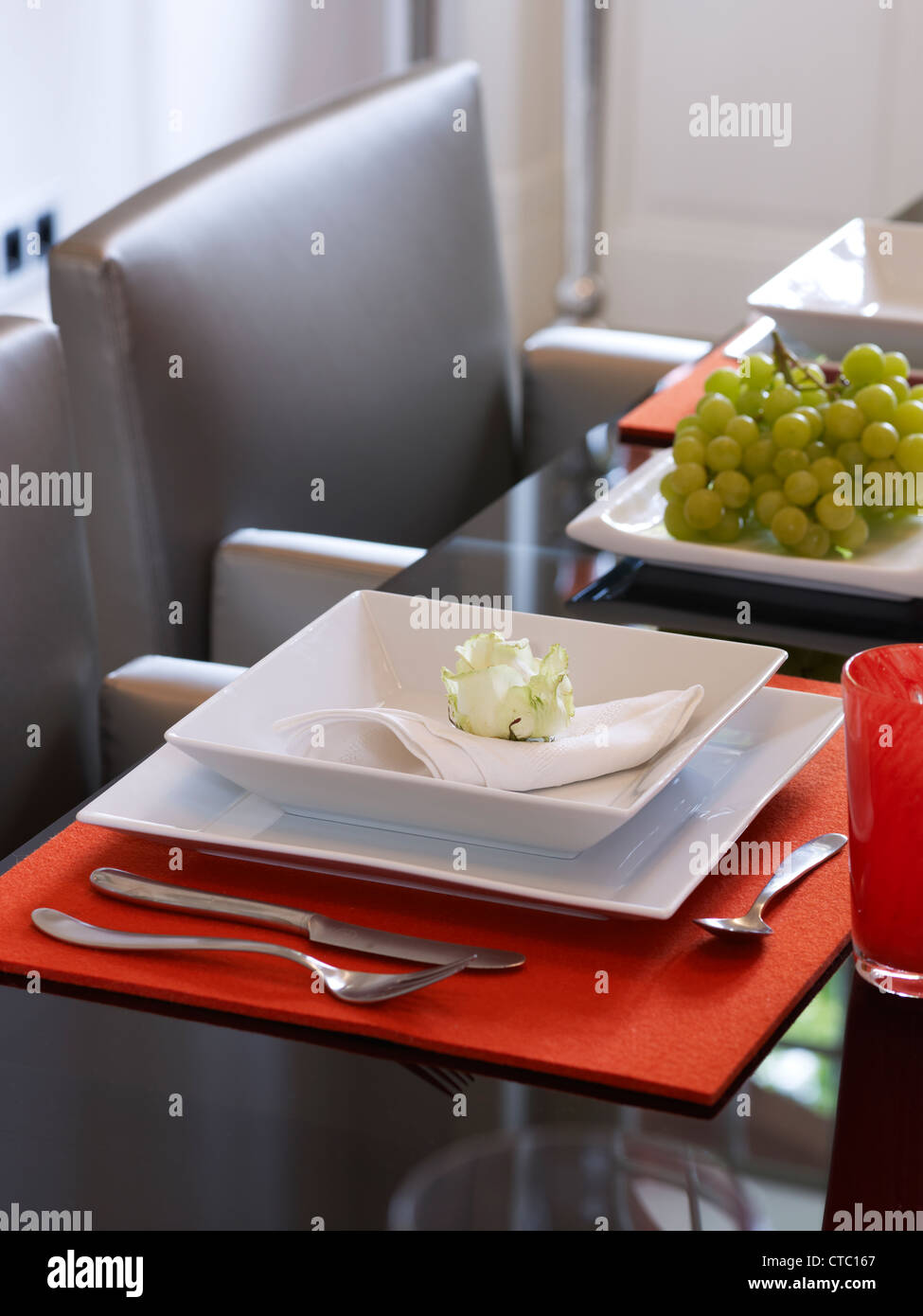 Modern plates on a well-laid table Stock Photo - Alamy