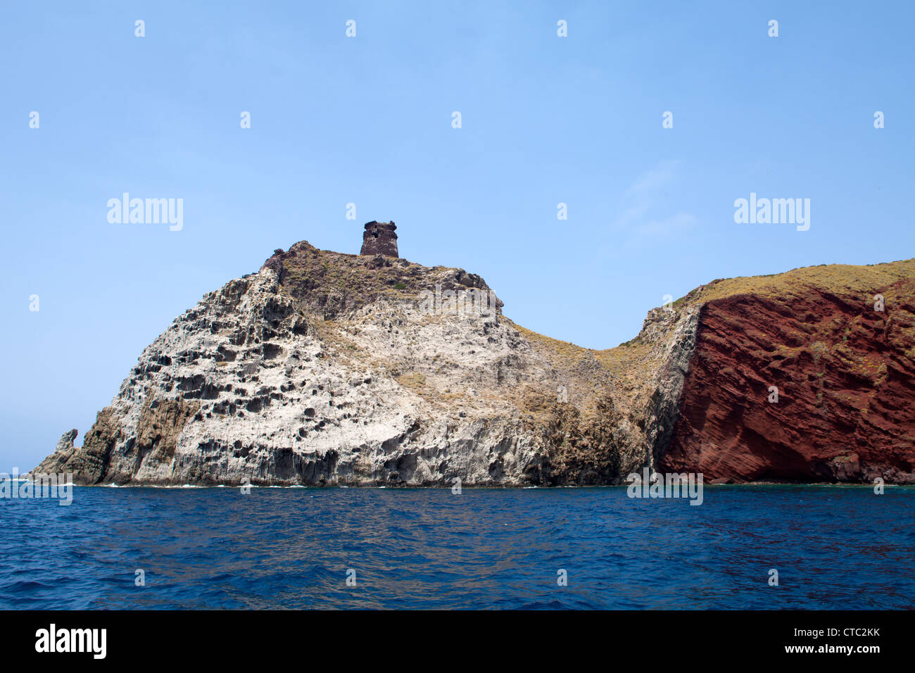 Volcanic formations and ancient tower on the top, Capraia Island ...