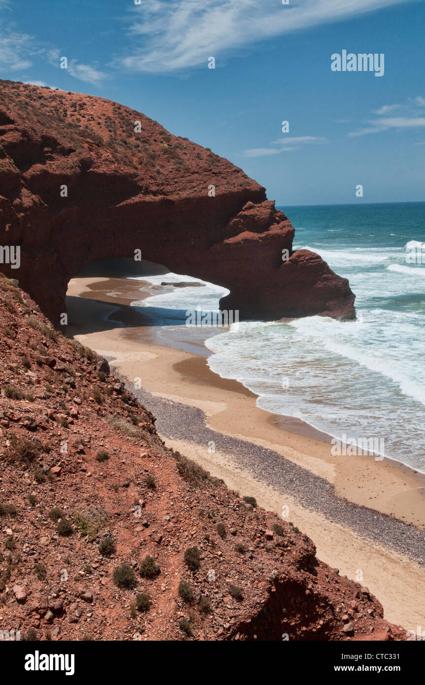 natural stone arch along the beach at Legzira Plage near Sidi Ifni ...