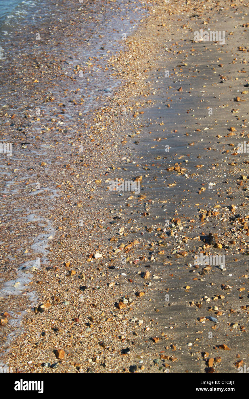 Waves breaking on to a shingle and sand beach Stock Photo - Alamy