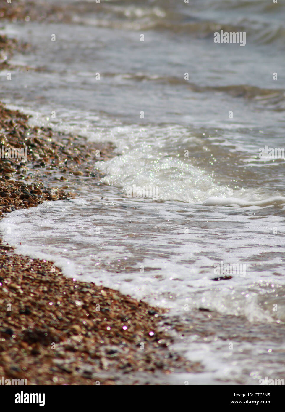 Waves on a shingle beach Stock Photo - Alamy