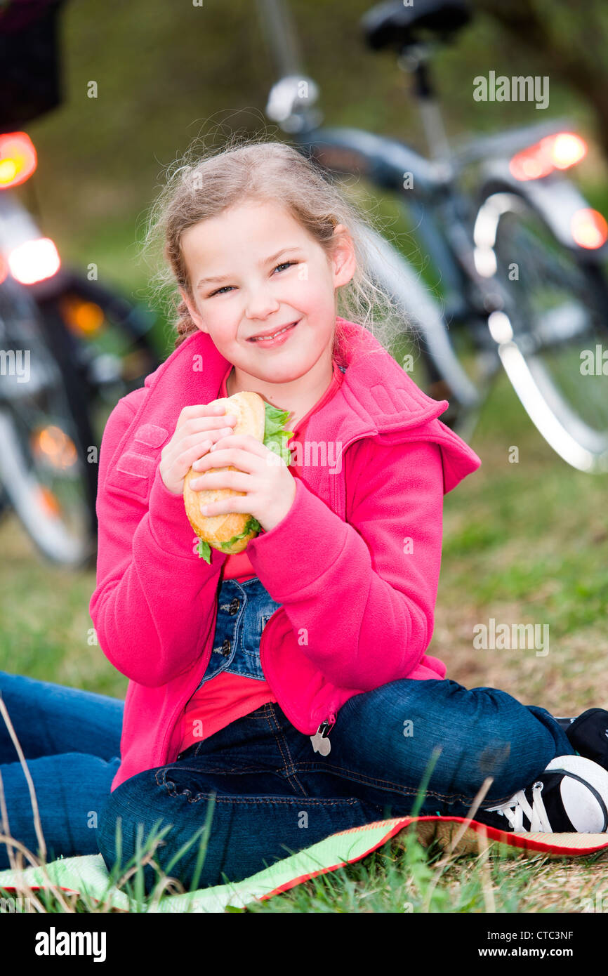 teeny girl with sandwich at picknick Stock Photo - Alamy