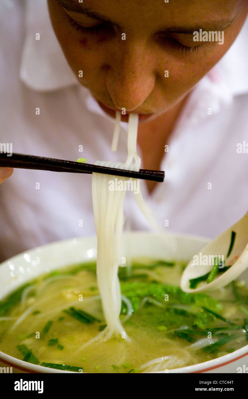 Western woman tourist eating fresh / authentic / real Chinese rice ...