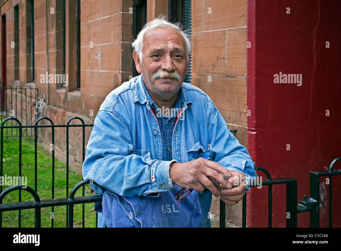 Robert Skull, a resident of Govan, Glasgow,standing outside his home in ...