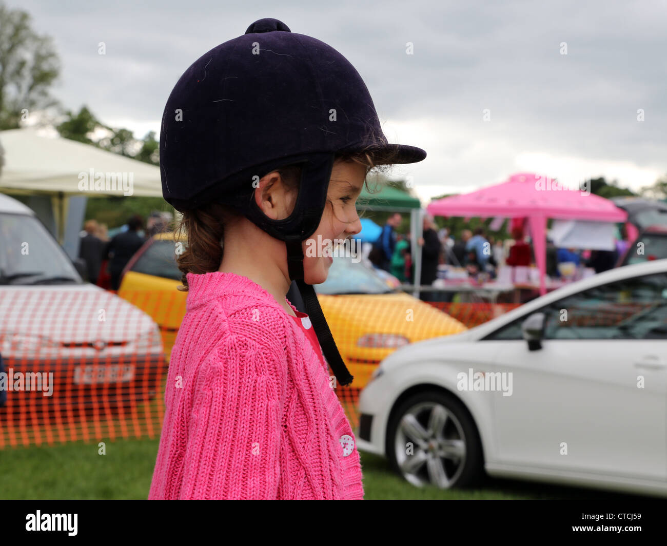 Girl Wearing Horse Riding Helmet At Cheam Village Fair Surrey England ...