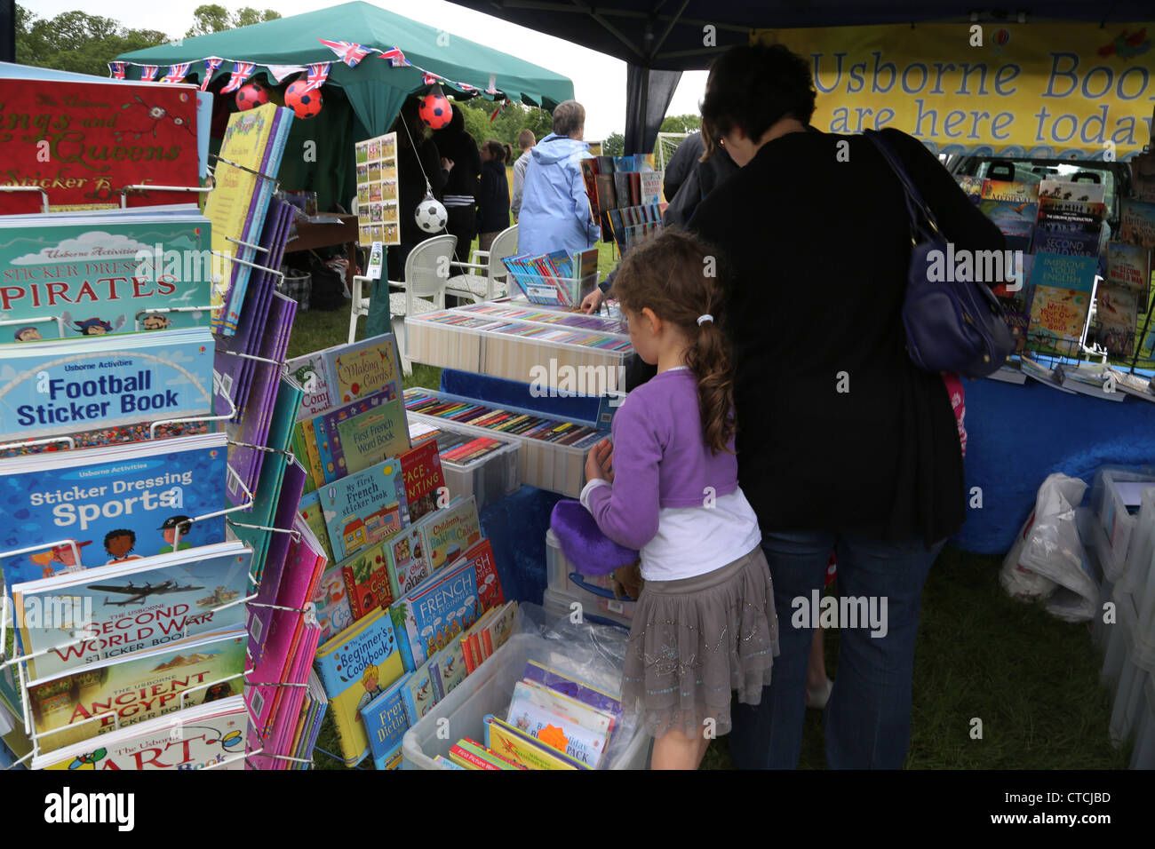 Mother And Children Choosing Books From Usborne Book Stand At Cheam ...
