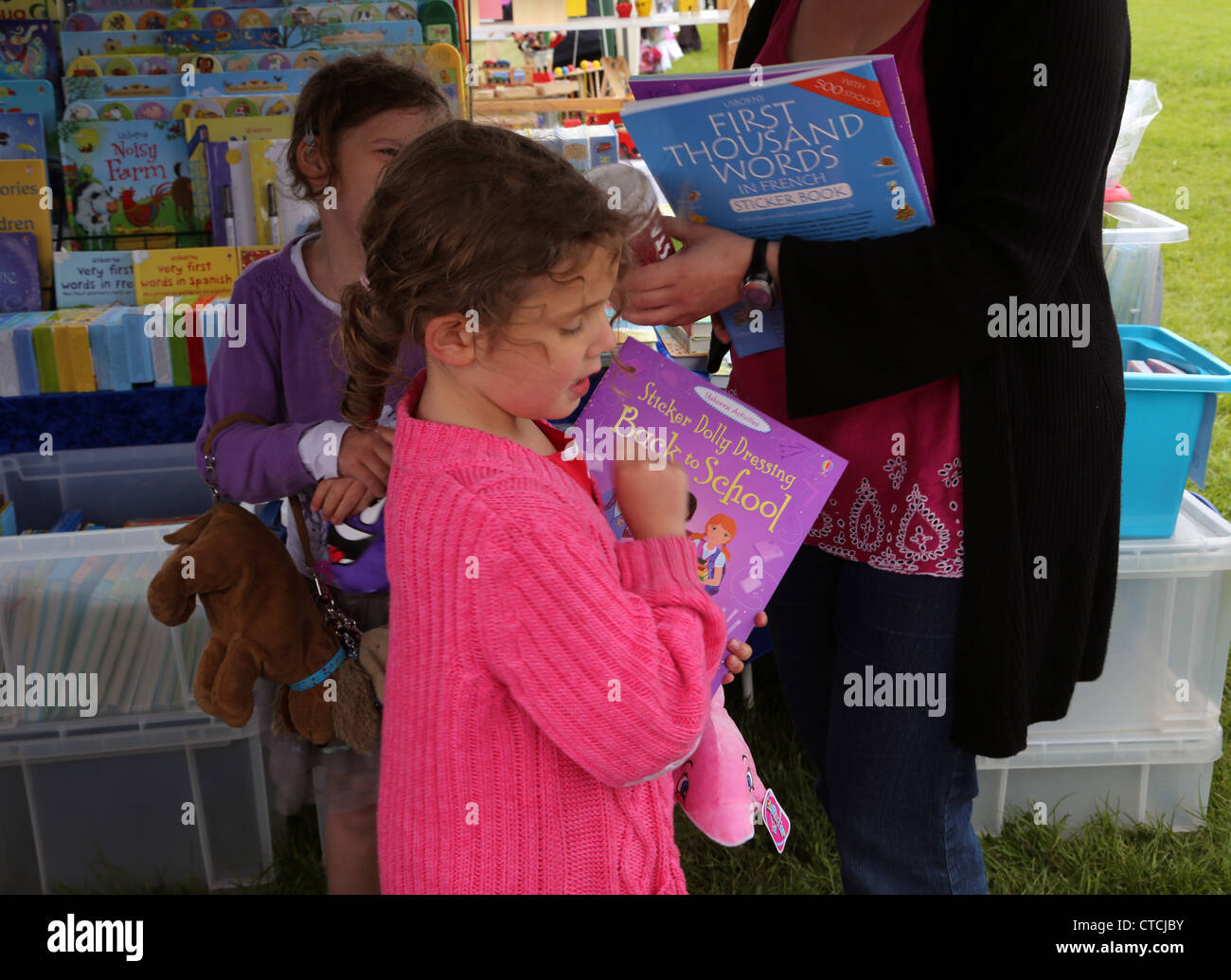 Mother And Children Choosing Books From Usborne Book Stand At Cheam ...