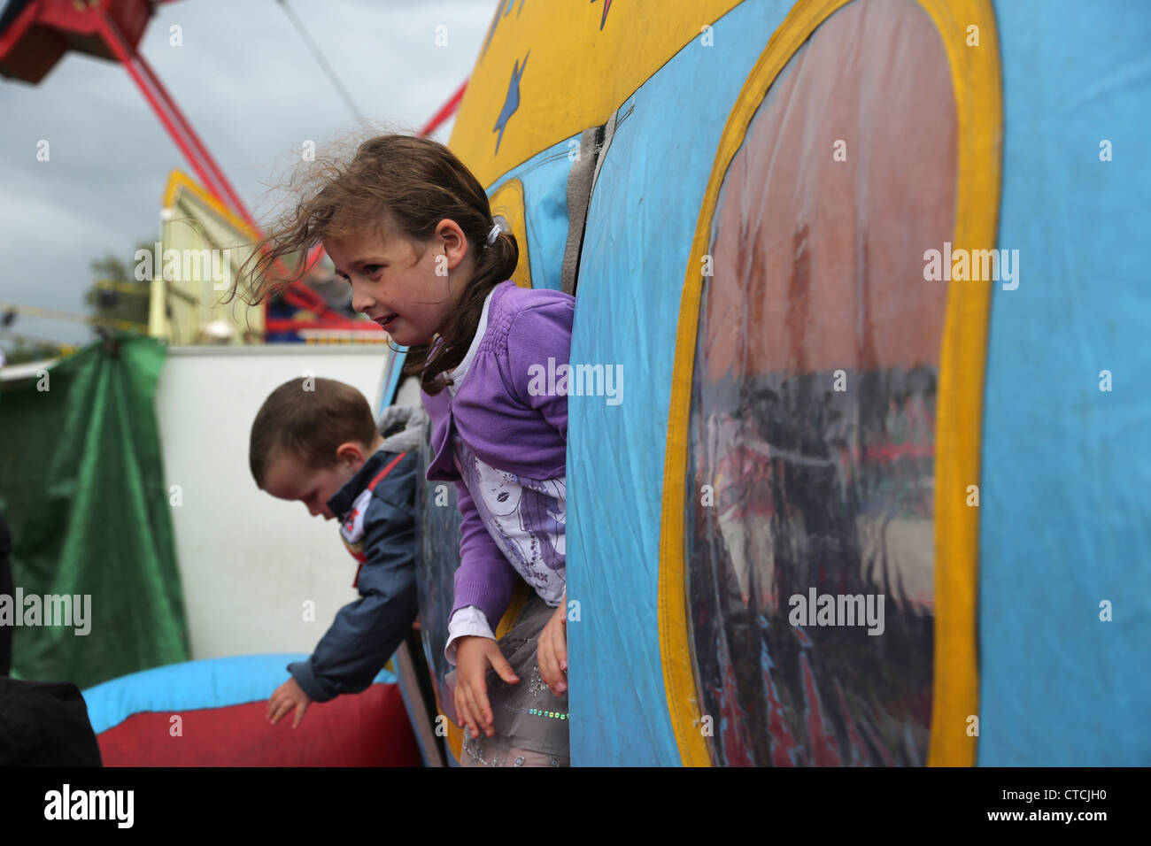 Children Looking out of Window Of Moonwalk Bouncy Castle At Cheam ...