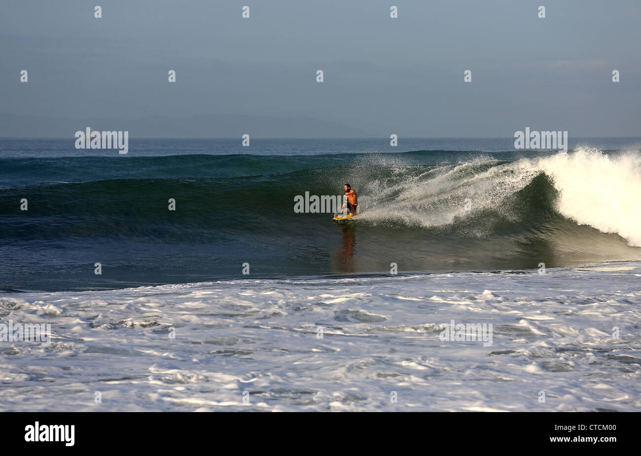 Man body surfing a large wave in West Java, Indonesia Stock Photo - Alamy