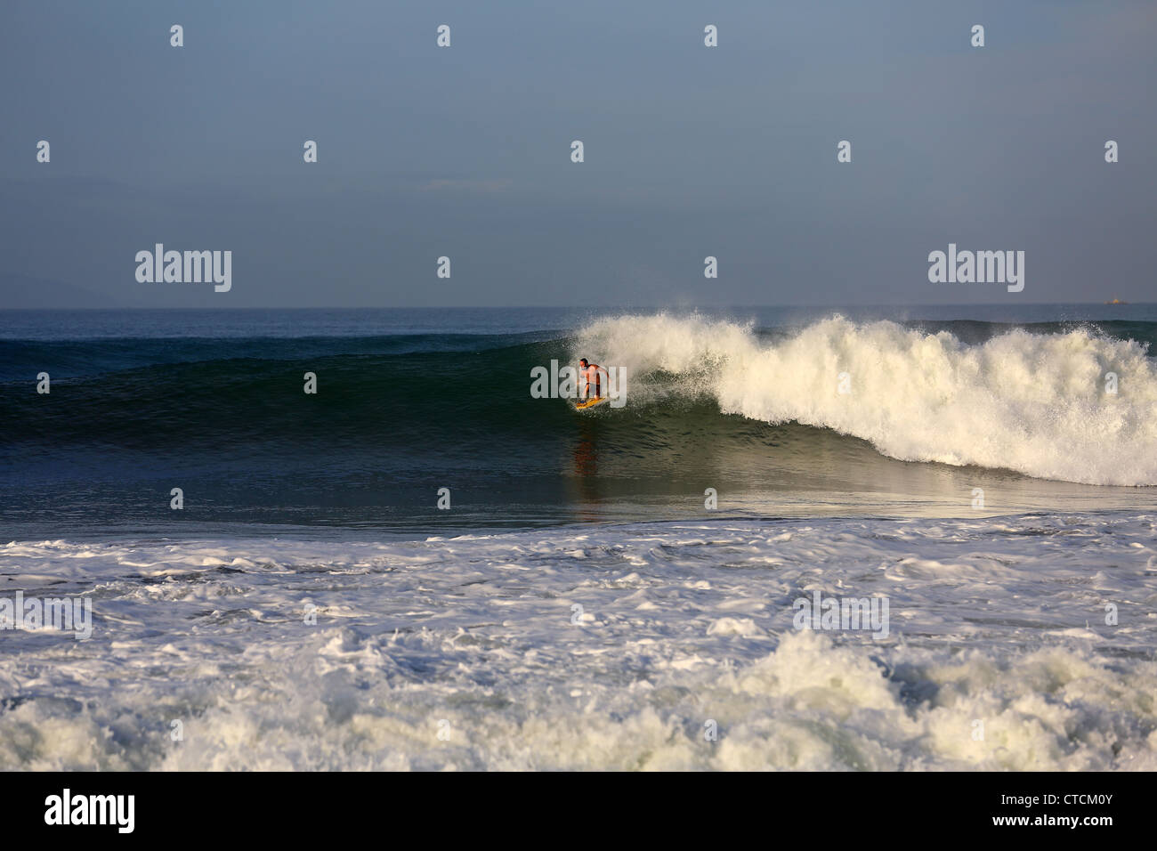 Man body surfing a large wave in West Java, Indonesia Stock Photo - Alamy