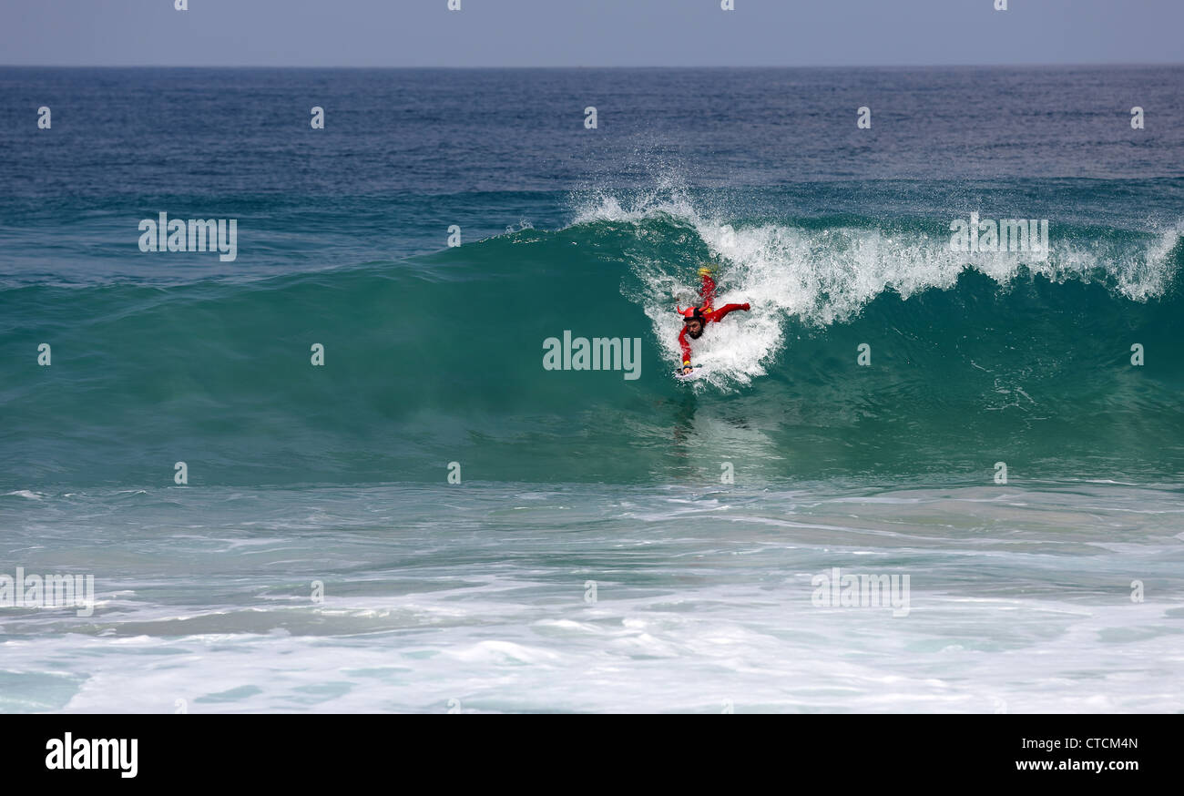 Man in red costume body surfing with hand ski in Sumatra Stock Photo ...