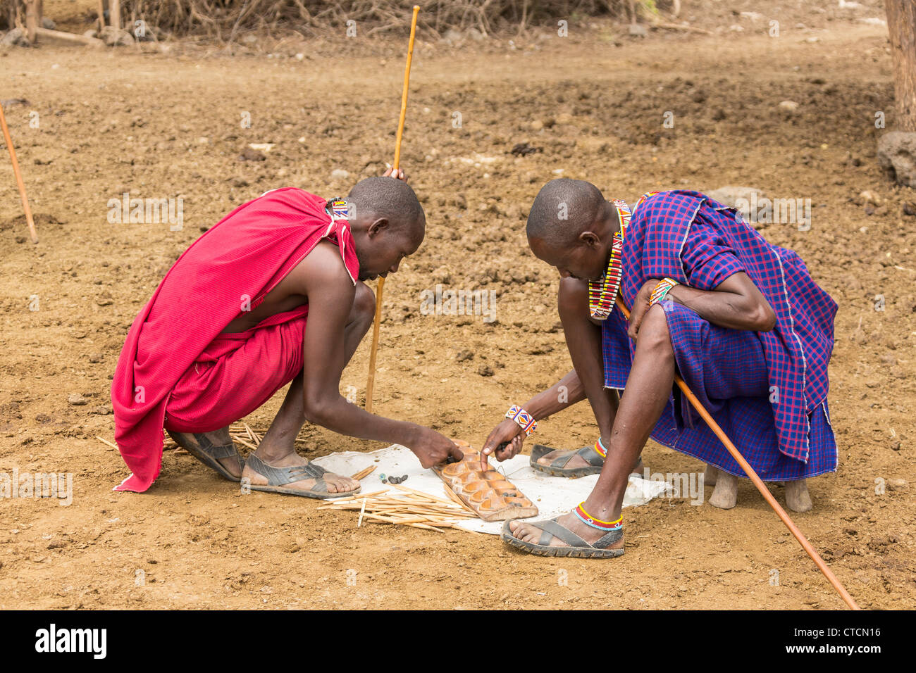 2 Masai Men playing a traditional game in village Stock Photo - Alamy