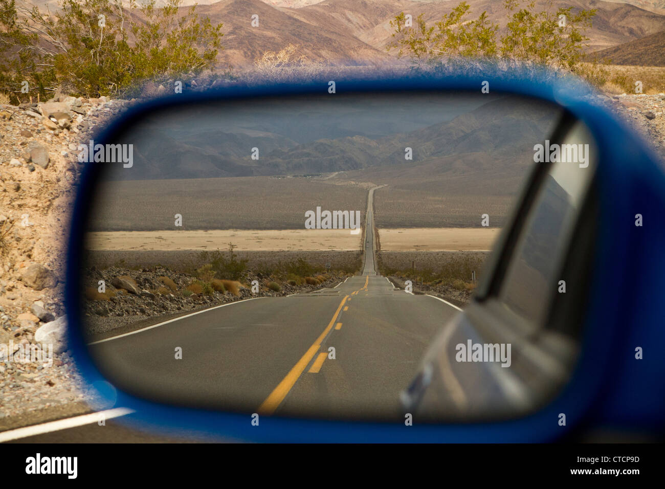 Driving down highway 190 in death valley with the long endless road in ...