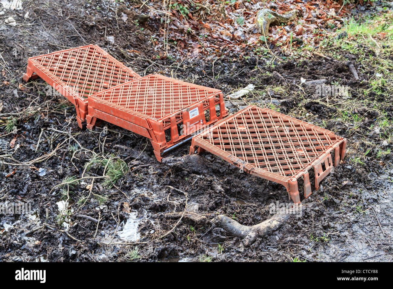 Trays make improvised bridge over muddy ditch Stock Photo - Alamy