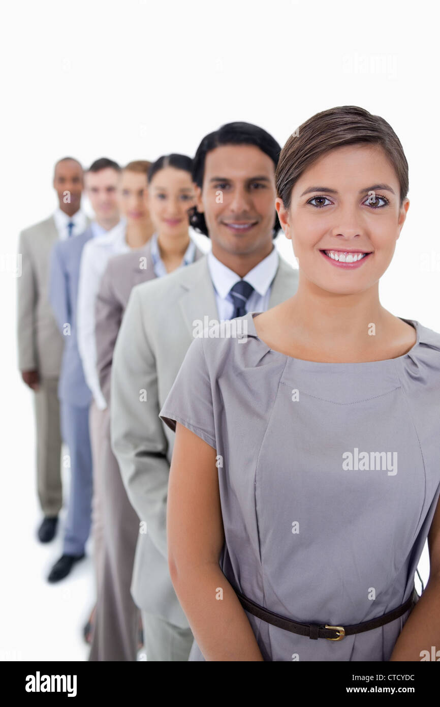 Close-up of colleagues in a single line smiling and looking straight ...