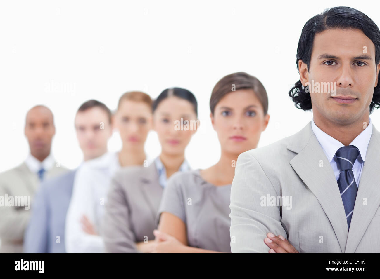 Big close-up of a serious business team in a single line looking ...