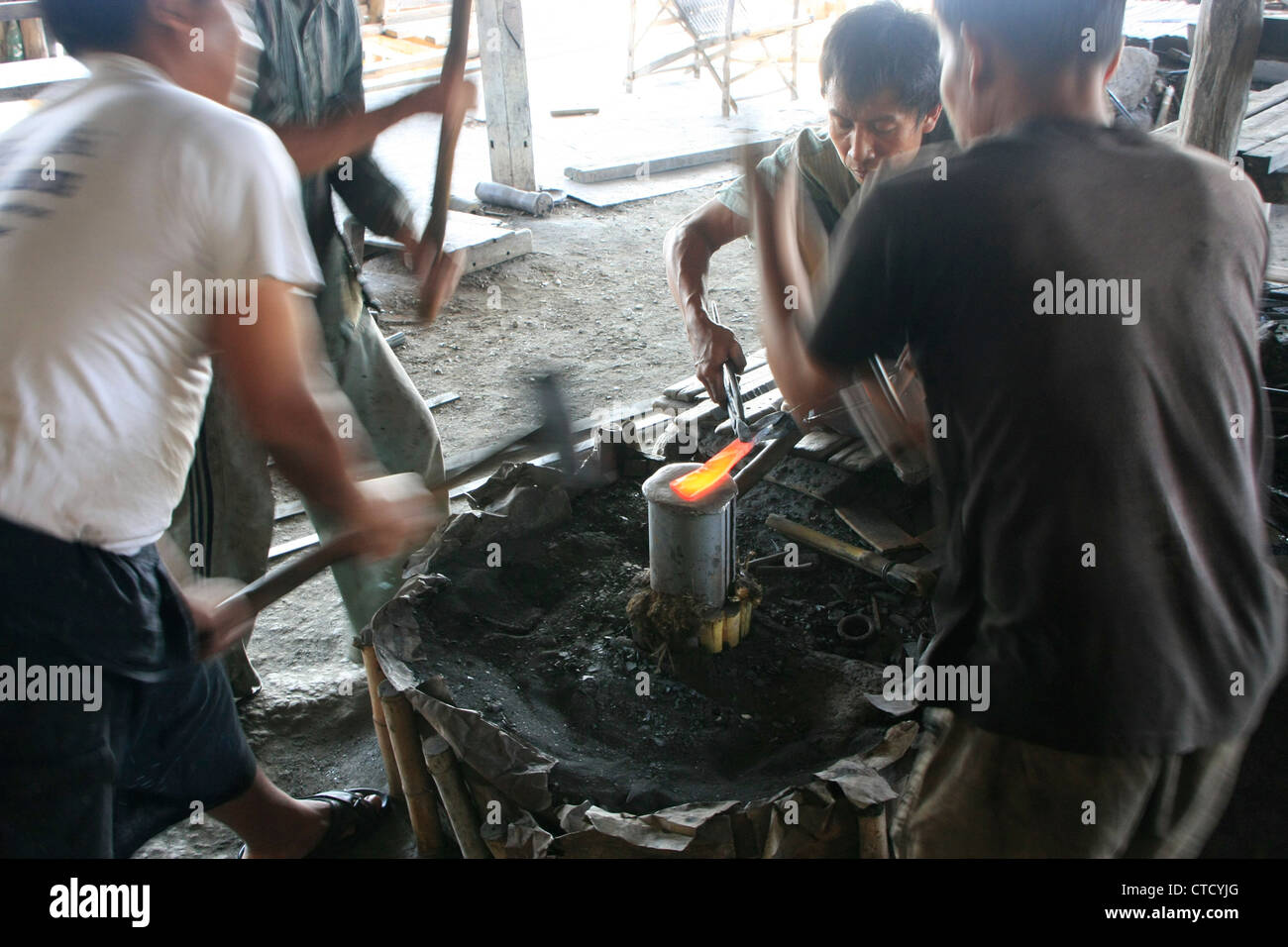Burmese men forging steel in a hearth, Inle lake, Shan state, Myanmar ...