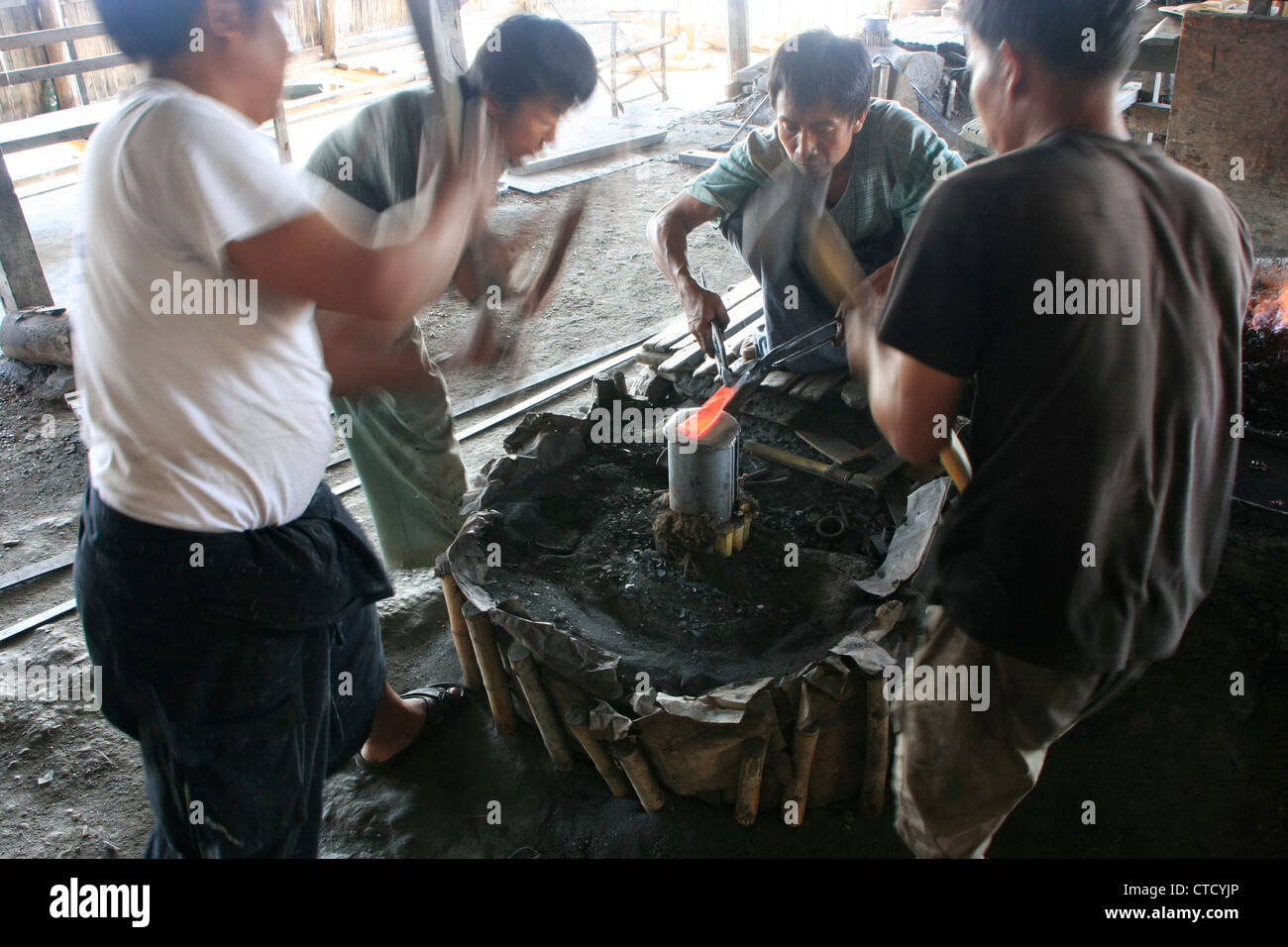 Burmese men forging steel in a hearth, Inle lake, Shan state, Myanmar ...