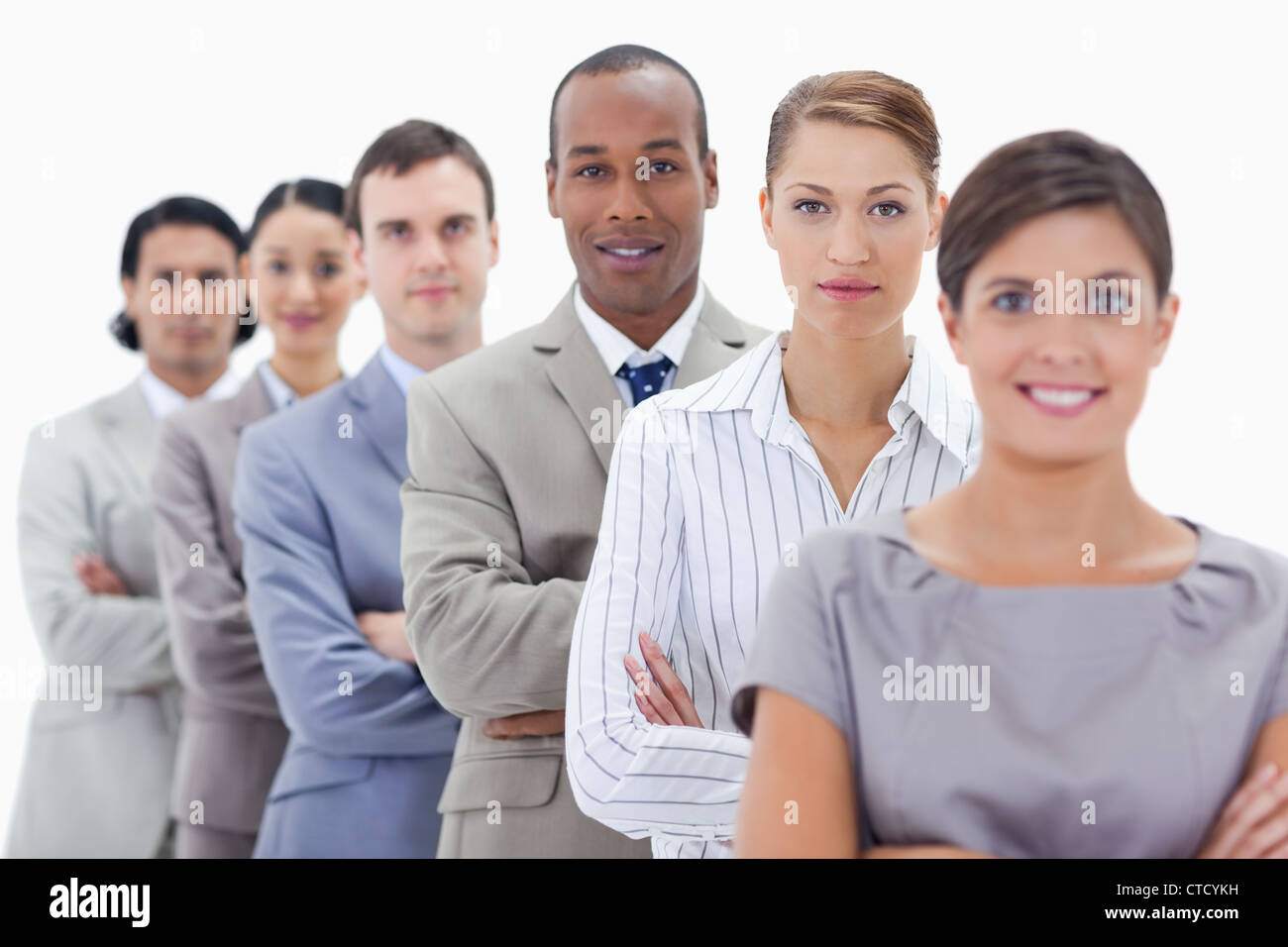 Big close-up of a business team in a single line crossing their arms ...