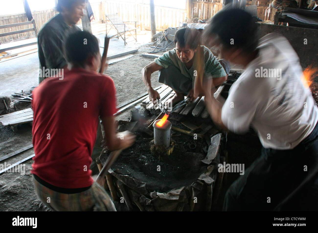 Burmese men forging steel in a hearth, Inle lake, Shan state, Myanmar ...