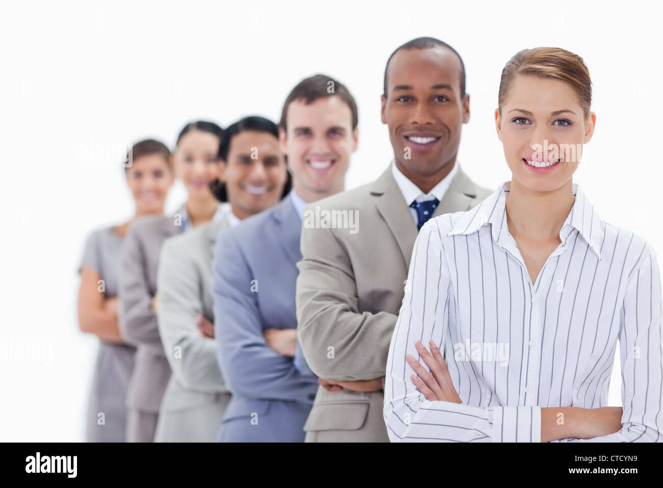 Close-up of smiling people dressed in suits crossing their arms in a ...