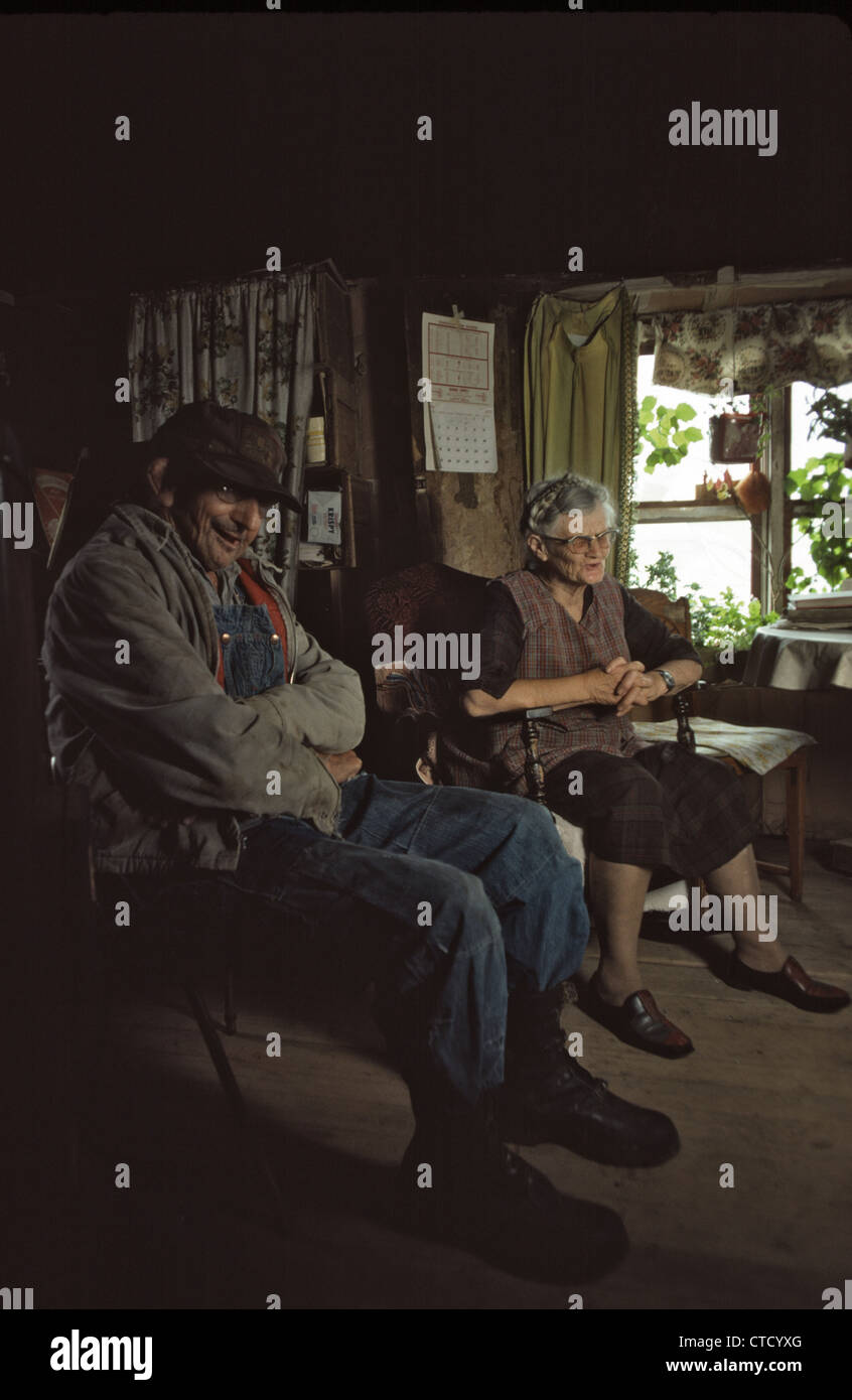 an old poor couple seated inside their sod house in Stapleton Nebraska ...