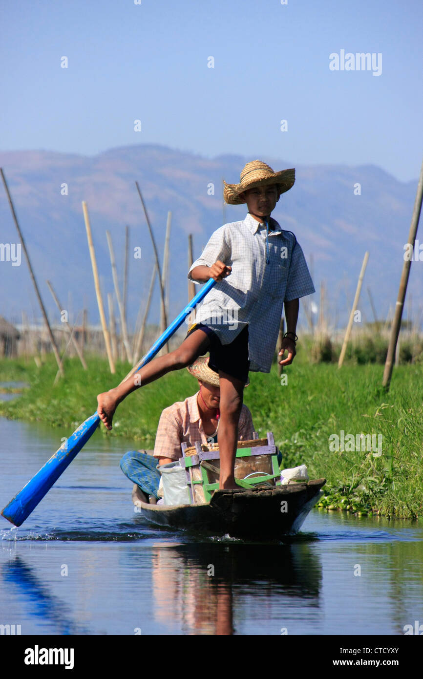 Burmese man rowing boat with one leg, Inle lake, Shan state, Myanmar ...