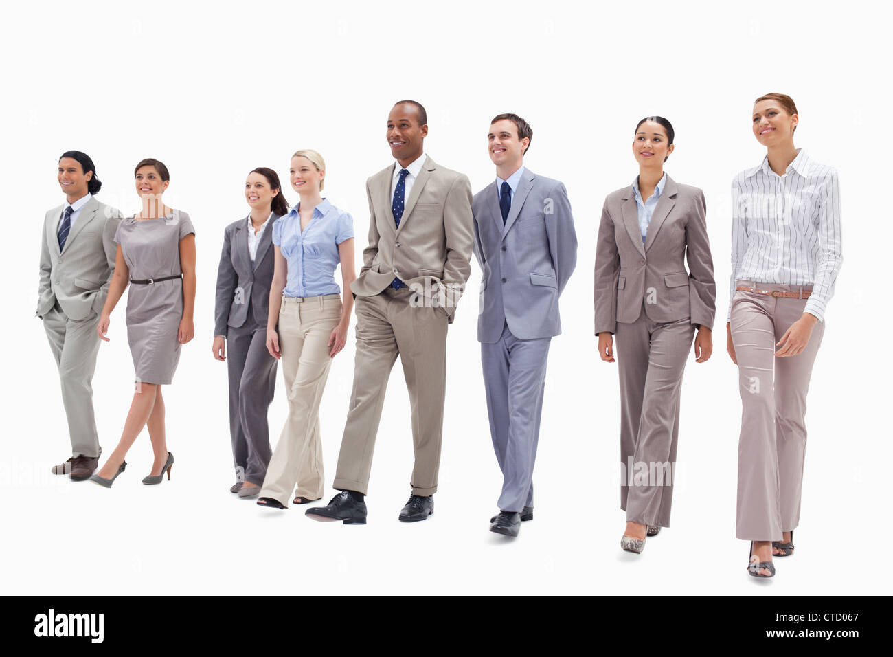 Happy business team walking Stock Photo - Alamy