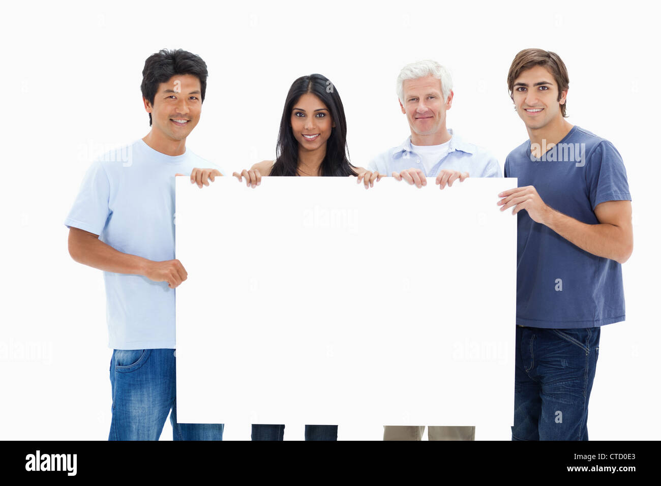 People in jeans holding a big sign Stock Photo - Alamy