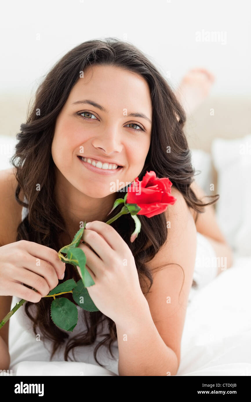 Young woman holding rose bed hi-res stock photography and images - Alamy